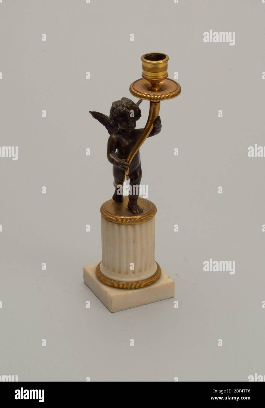 Pair of candlesticks. Each candlestick has a square plinth and ...