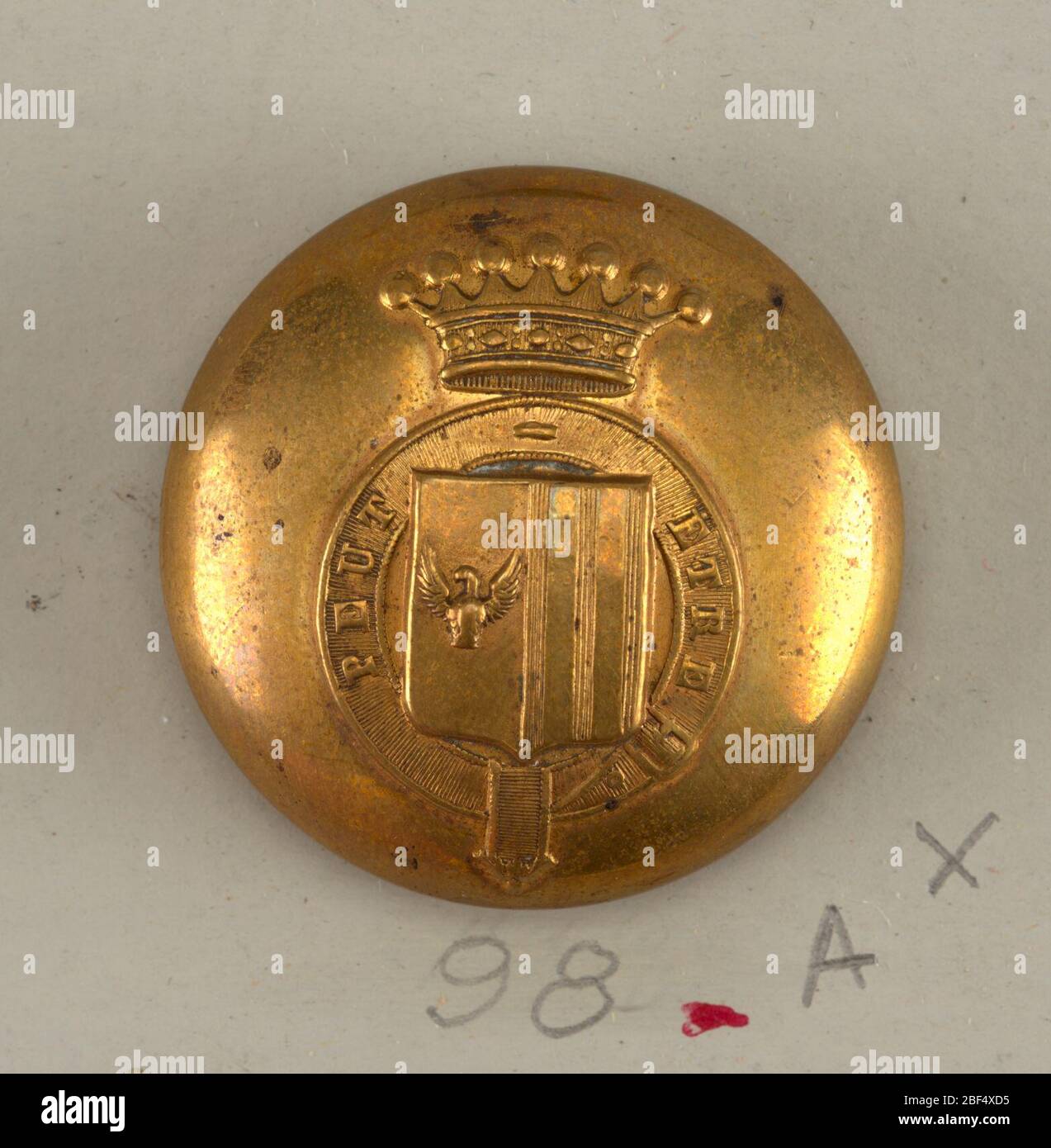 Button. Circular button; shield with bird at left and vertical stripes ...