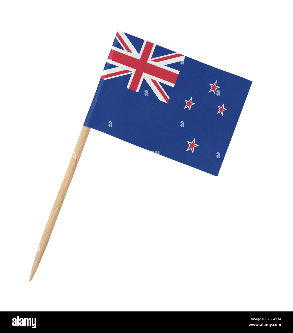 Small paper flag of New Zealand on wooden stick, isolated on white ...