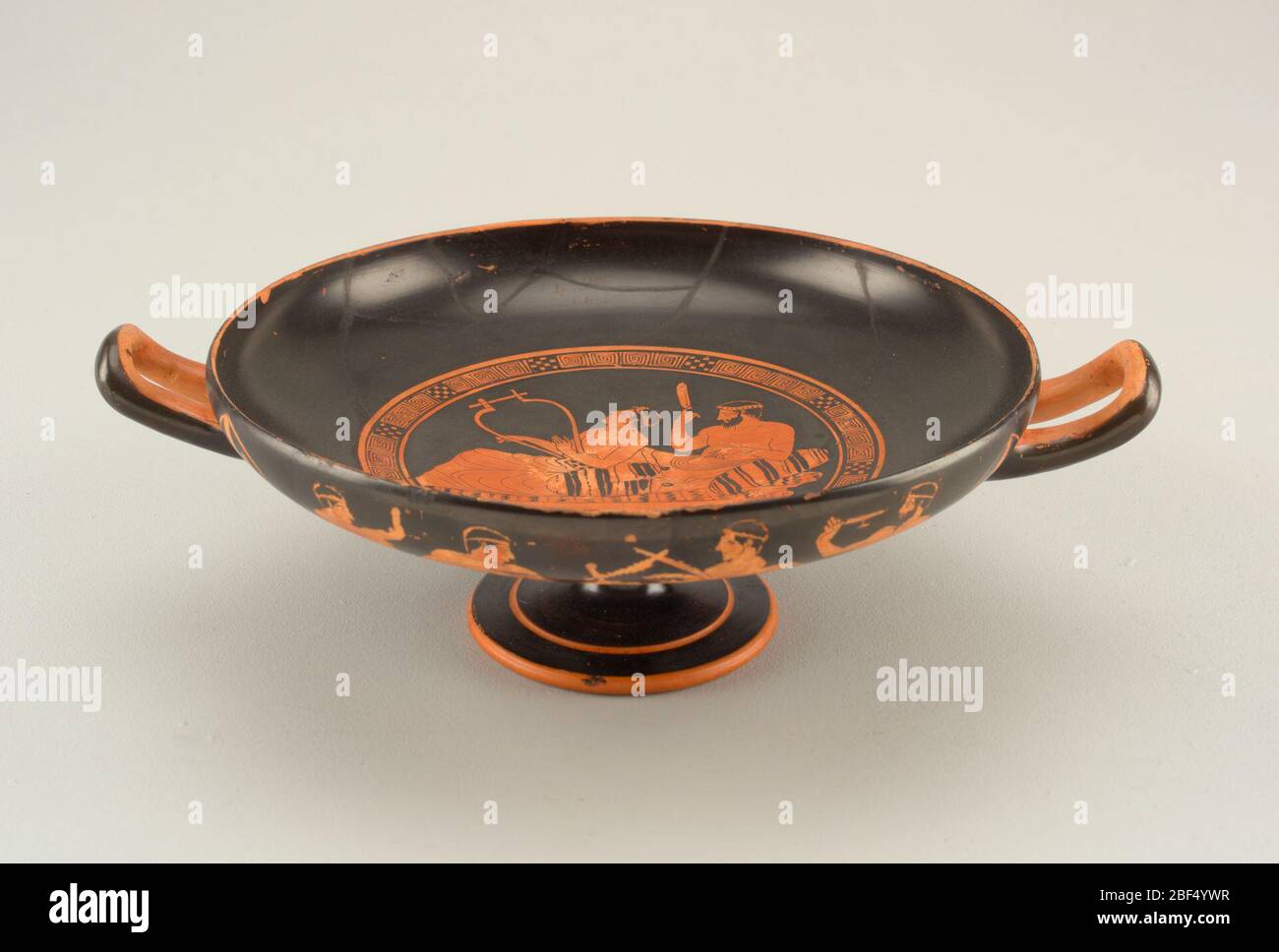 Kylix. Shallow circular bowl on pedestal foot; two, squared-loop ...