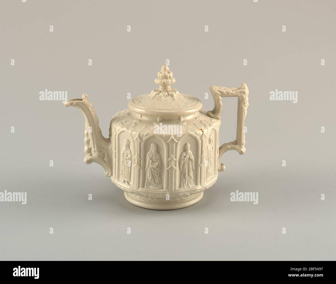 Apostles. A highly decorative white teapot and lid with detail on the ...