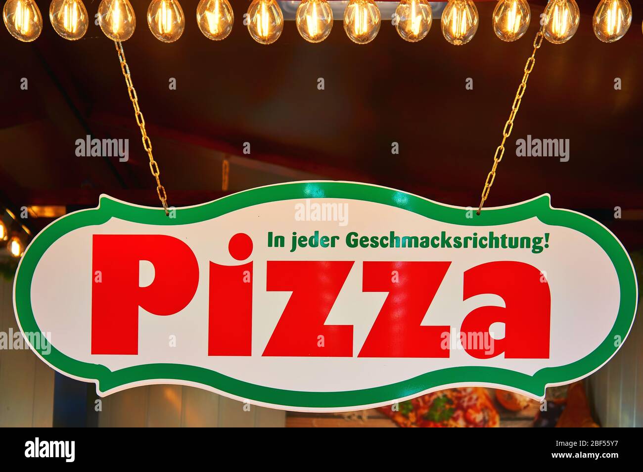 Illuminated pizza shop sign. Letters with In jeder Geschmacksrichtung ...