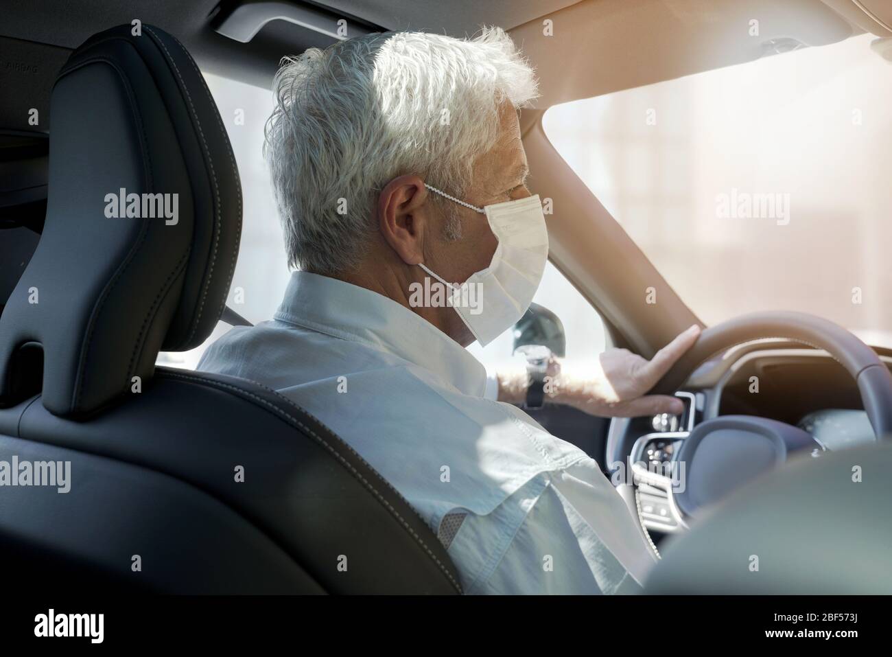 Man driving car and wearing face mask during COVID19 pandemic Stock ...