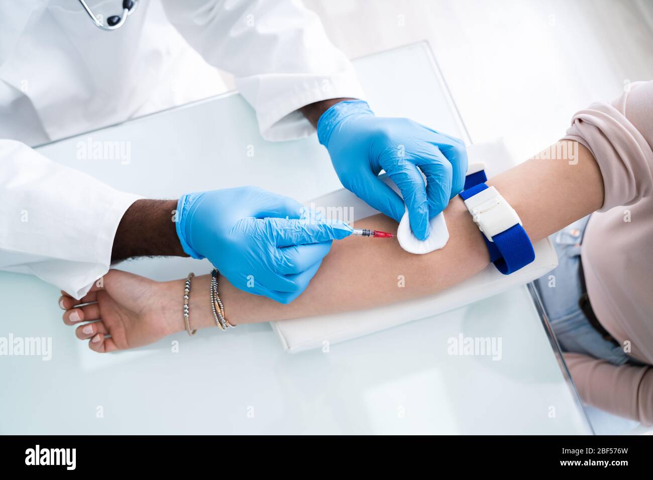 Close-up Of Female Doctor Injecting Male Patient With Syringe To ...