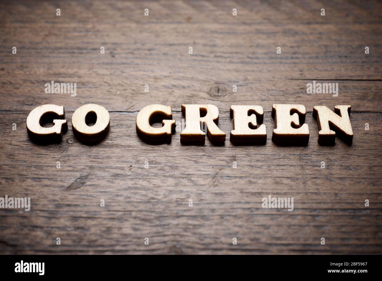 Go green text on a wood table Stock Photo - Alamy