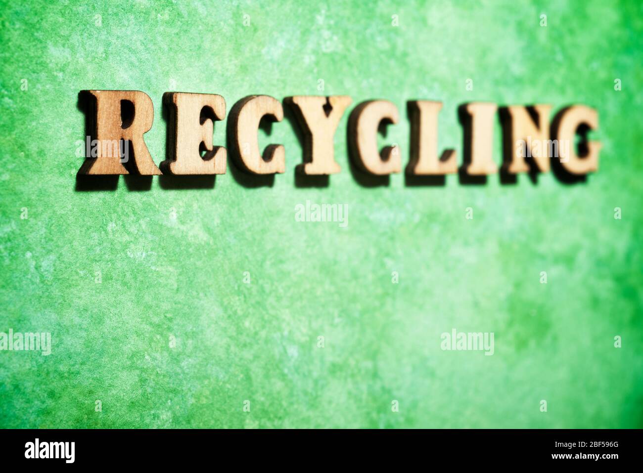 Recycling word on a green paper Stock Photo - Alamy