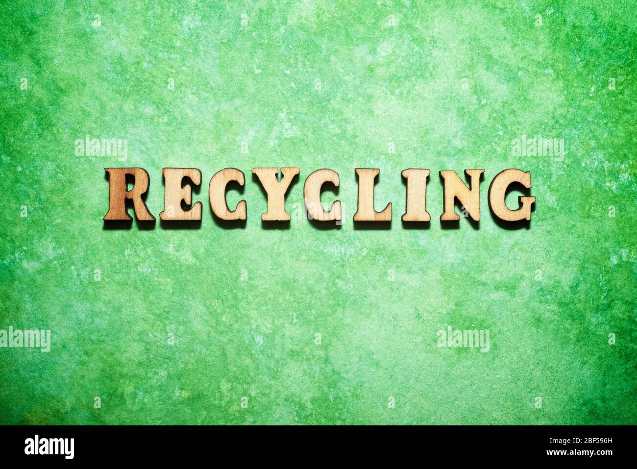 Recycling word on a green paper Stock Photo - Alamy