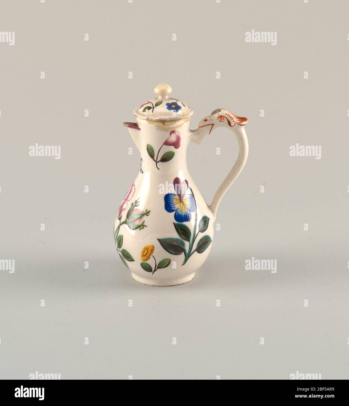 Cruet with cover. Baluster-form white cruet with short spout, decorated ...