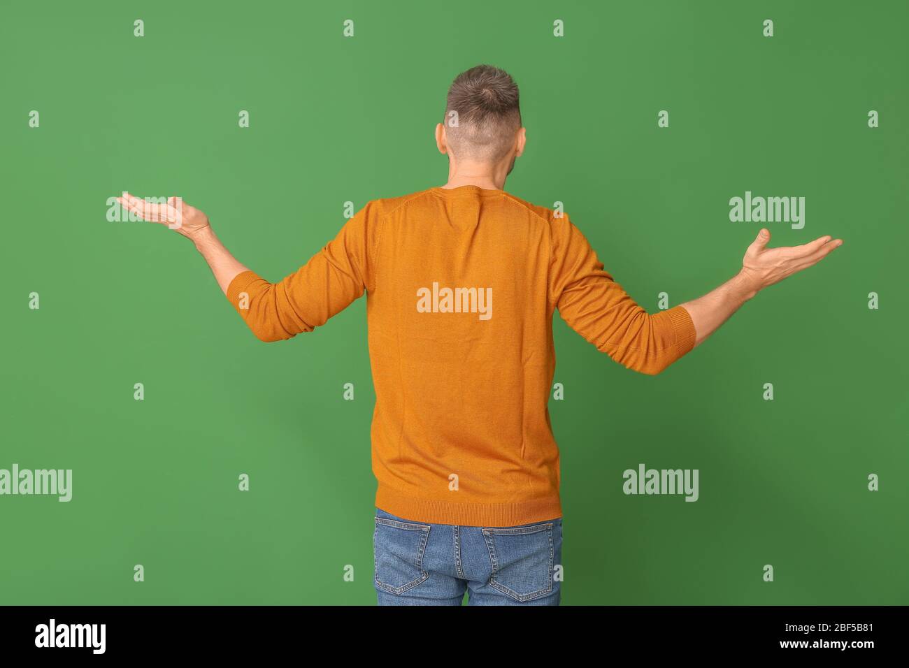 Helpless man on color background, back view. Concept of choice Stock ...