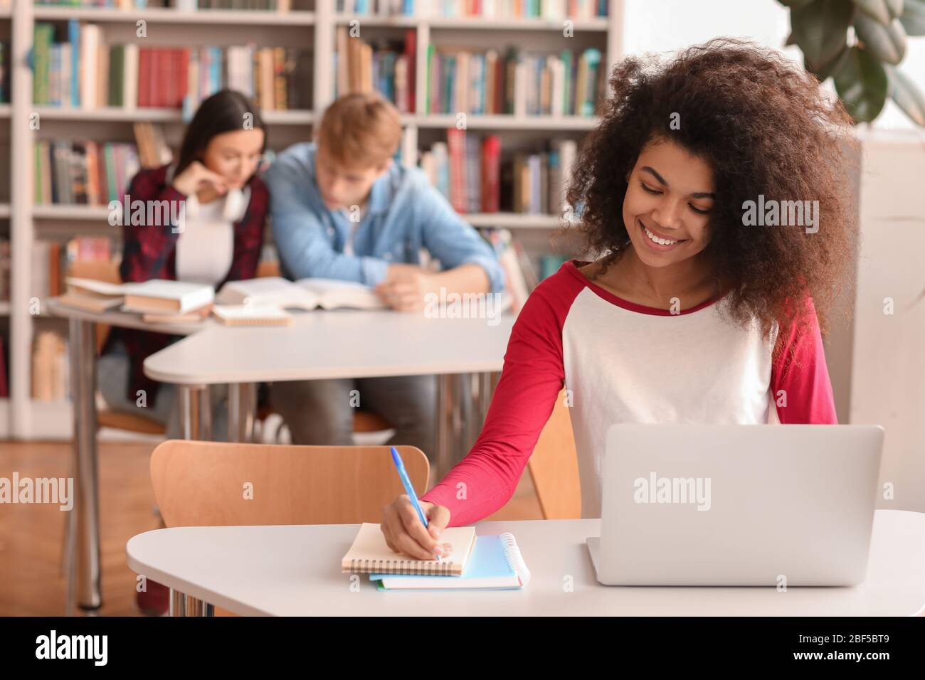 African-American student preparing for exam in library Stock Photo - Alamy