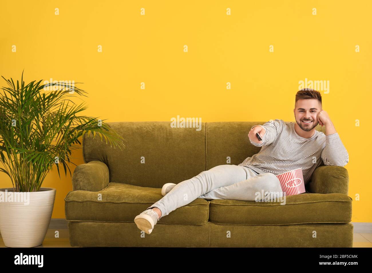 Lazy guy on couch watching hi-res stock photography and images - Alamy