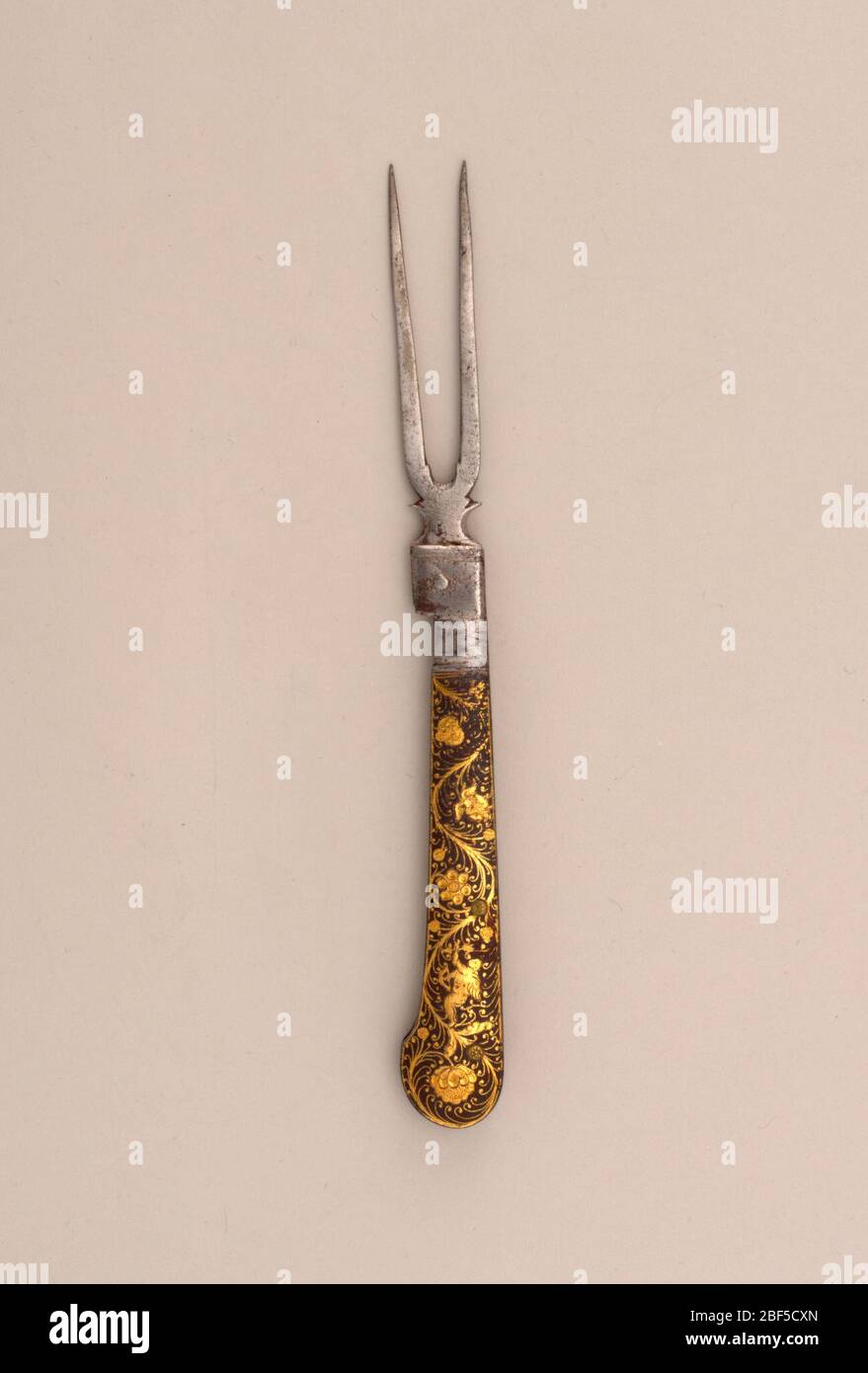 Folding fork. Fork has two flat tines, decorative chiseling at the join ...