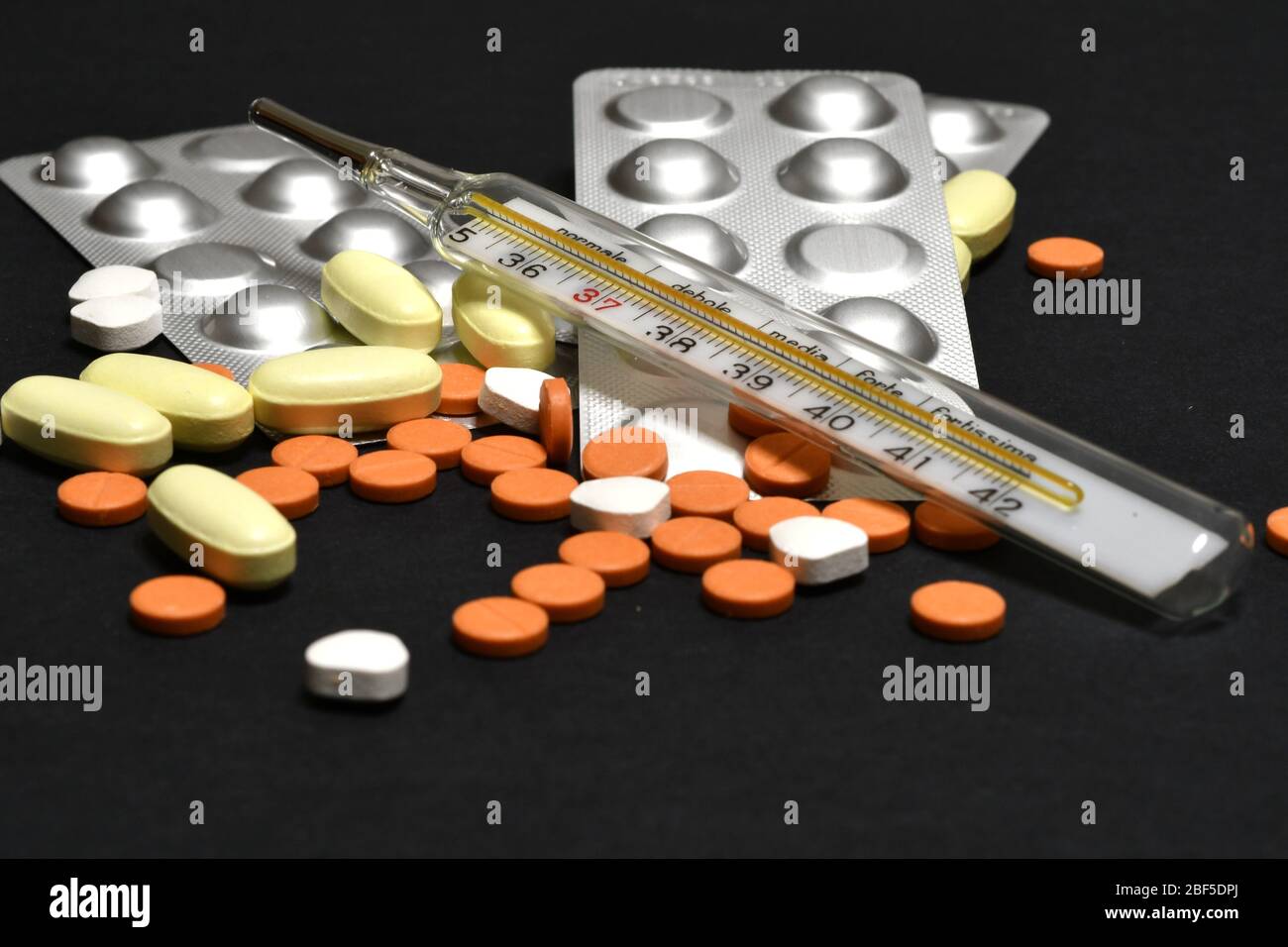 medicine pills with fever thermometer Stock Photo - Alamy