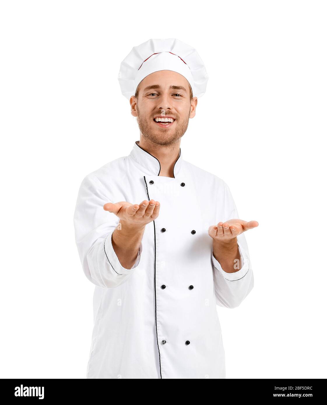 Handsome male chef showing something on white background Stock Photo ...