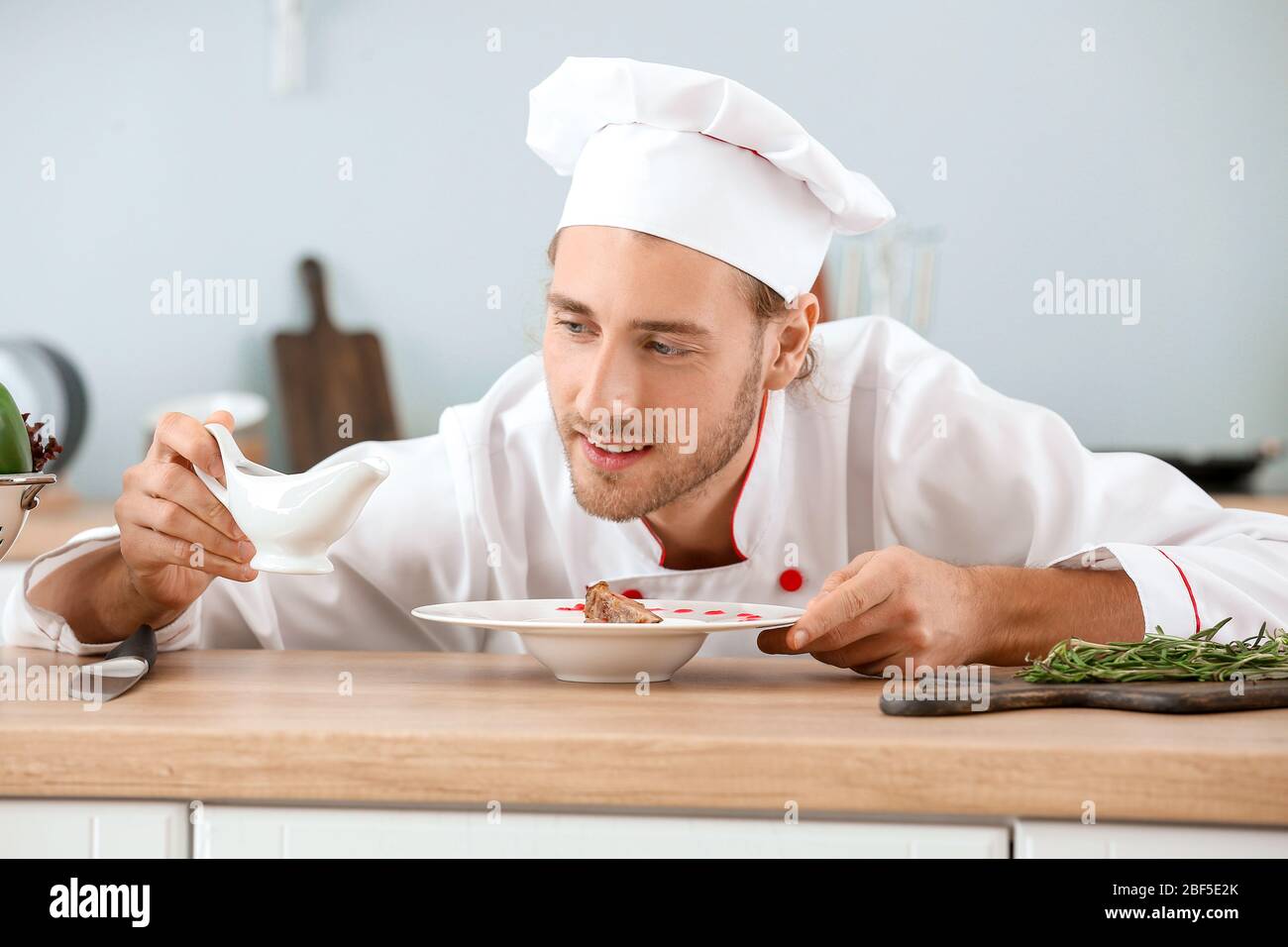 Male chef cooking in kitchen Stock Photo - Alamy