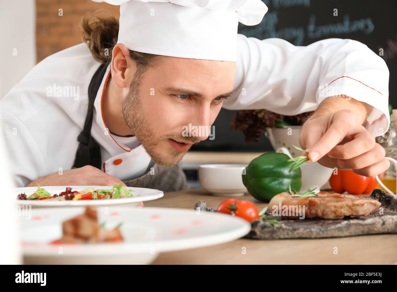 Male chef cooking in kitchen Stock Photo - Alamy
