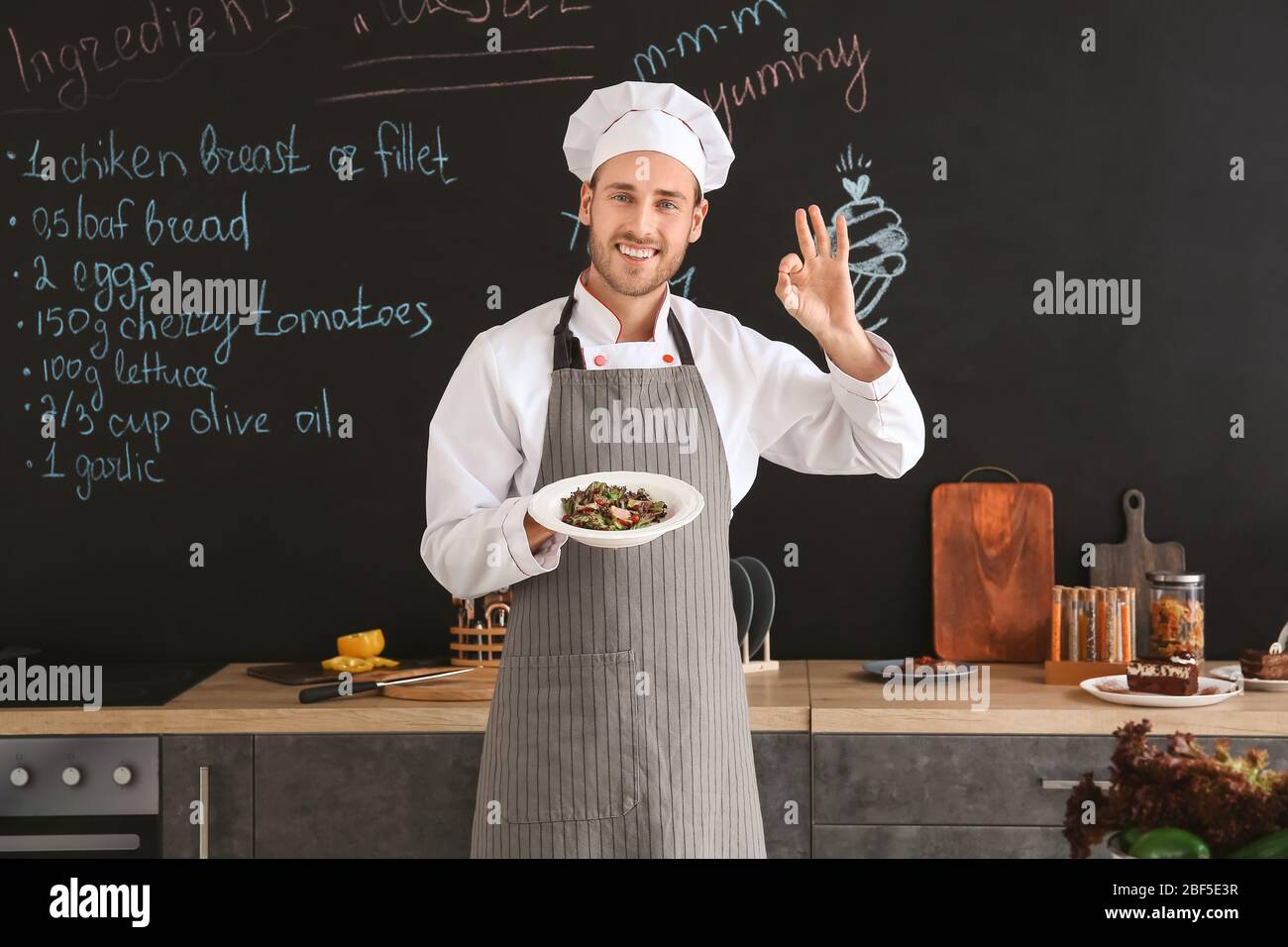 Happy male chef with prepared dish in kitchen Stock Photo - Alamy