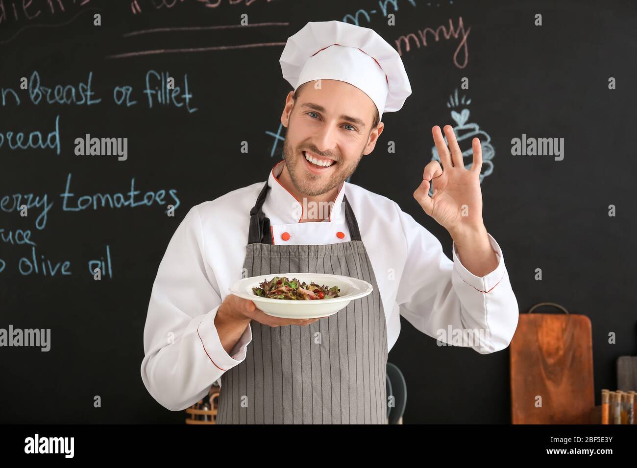 Happy male chef with prepared dish in kitchen Stock Photo - Alamy