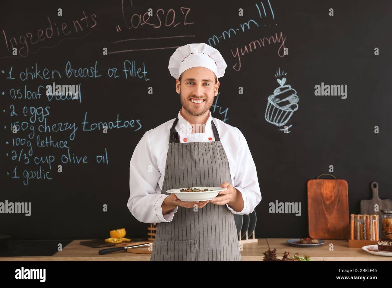 Happy male chef with prepared dish in kitchen Stock Photo - Alamy