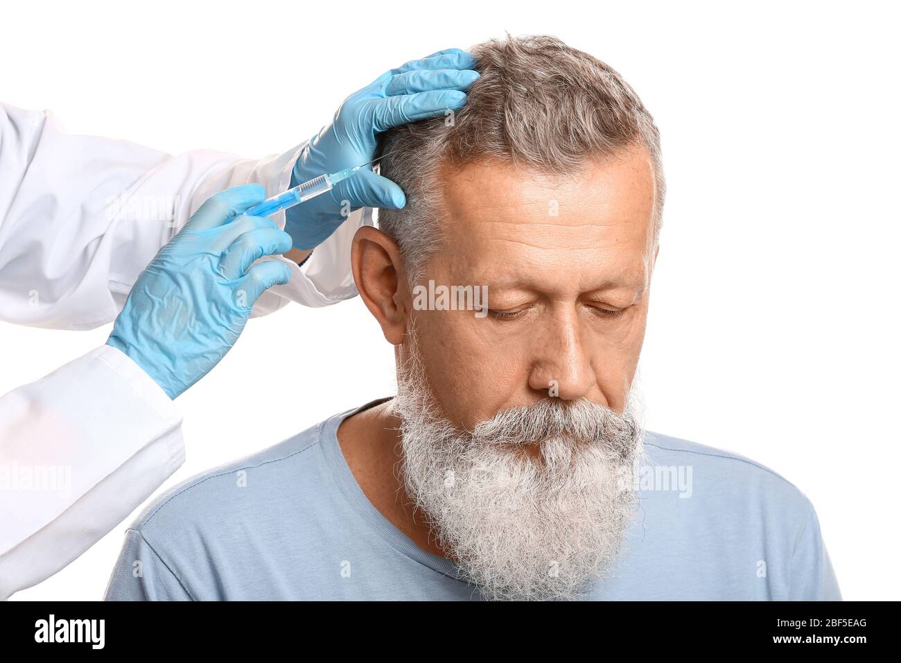 Senior man with hair loss problem receiving injection on white ...