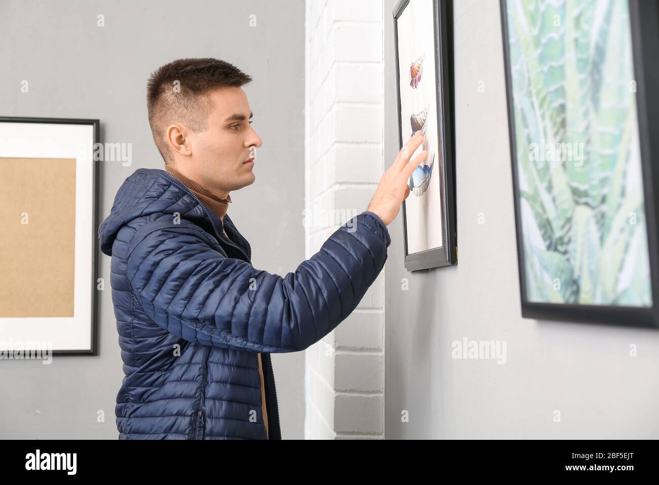 Man at exhibition in modern art gallery Stock Photo - Alamy