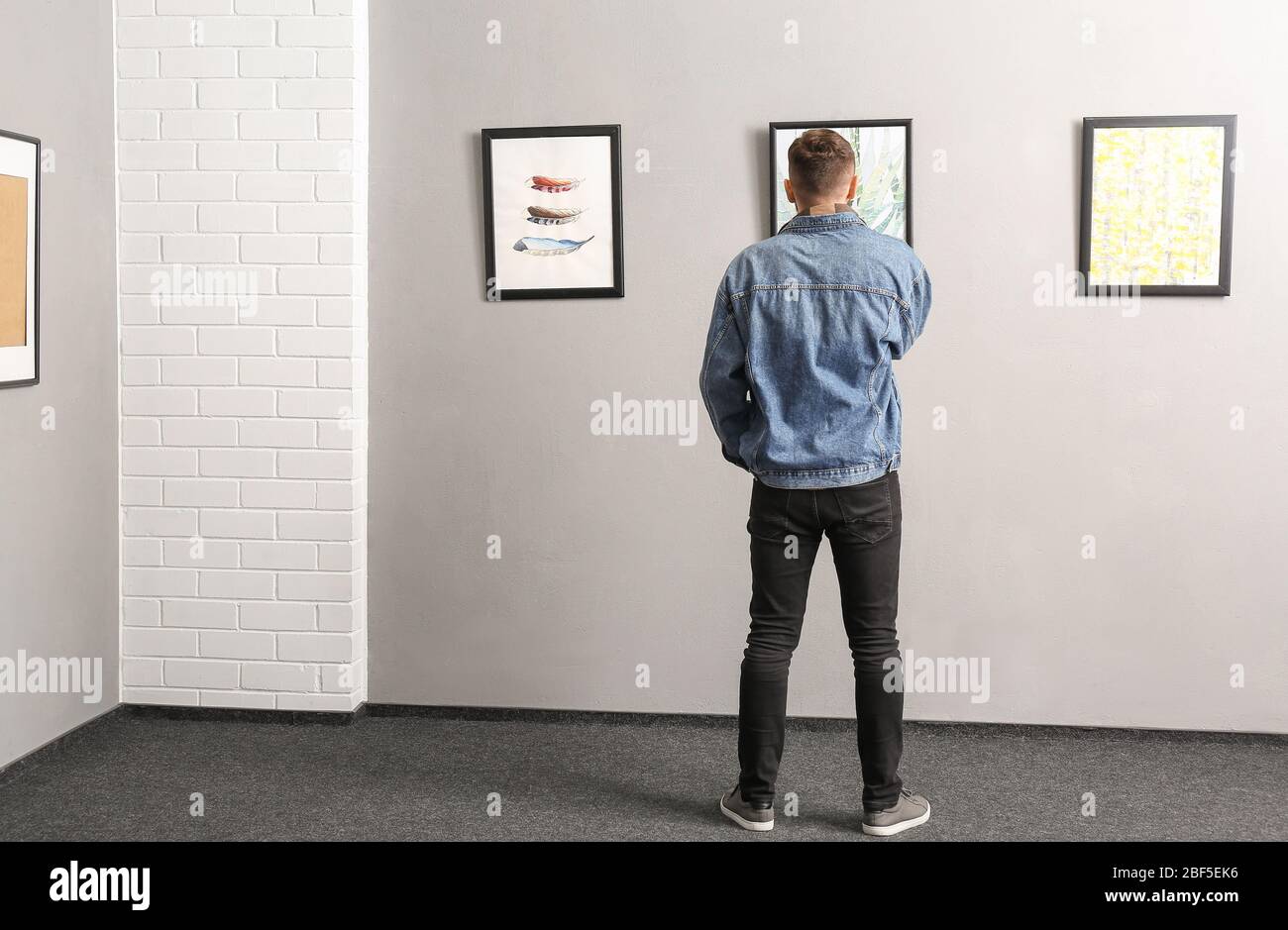 Man at exhibition in modern art gallery Stock Photo - Alamy