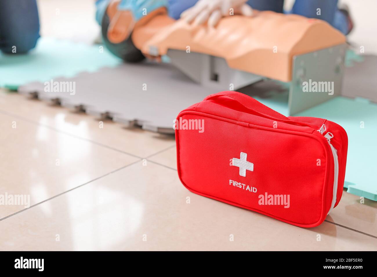 First aid kit on floor at training course Stock Photo - Alamy