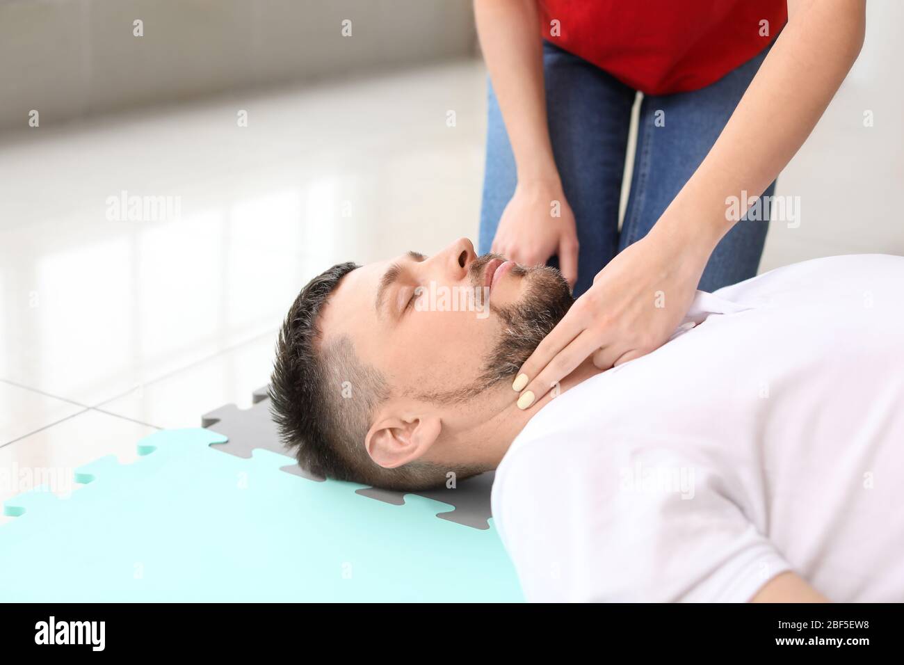 Instructor demonstrating CPR on man at first aid training course Stock ...