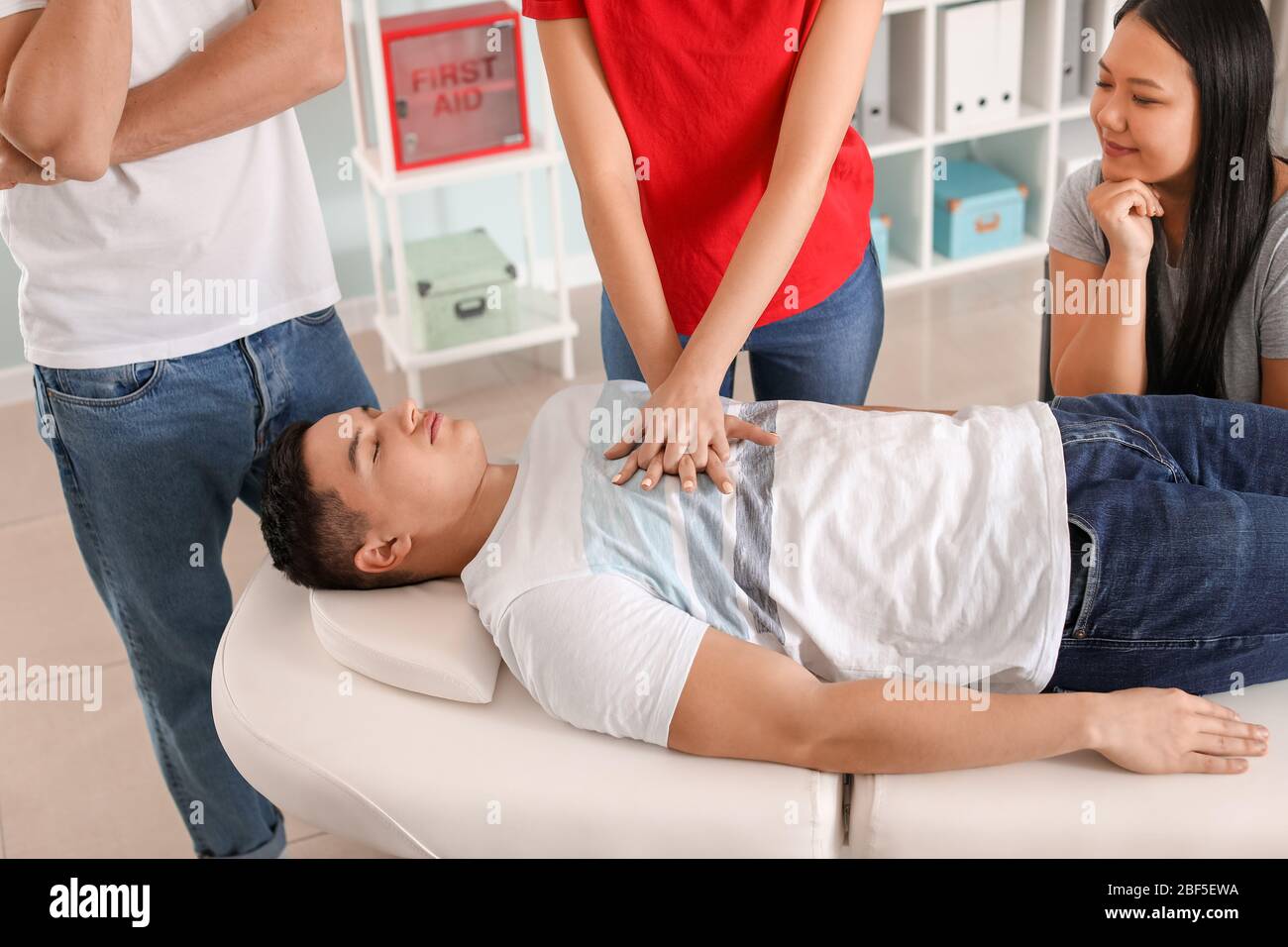 Instructor demonstrating CPR on man at first aid training course Stock ...