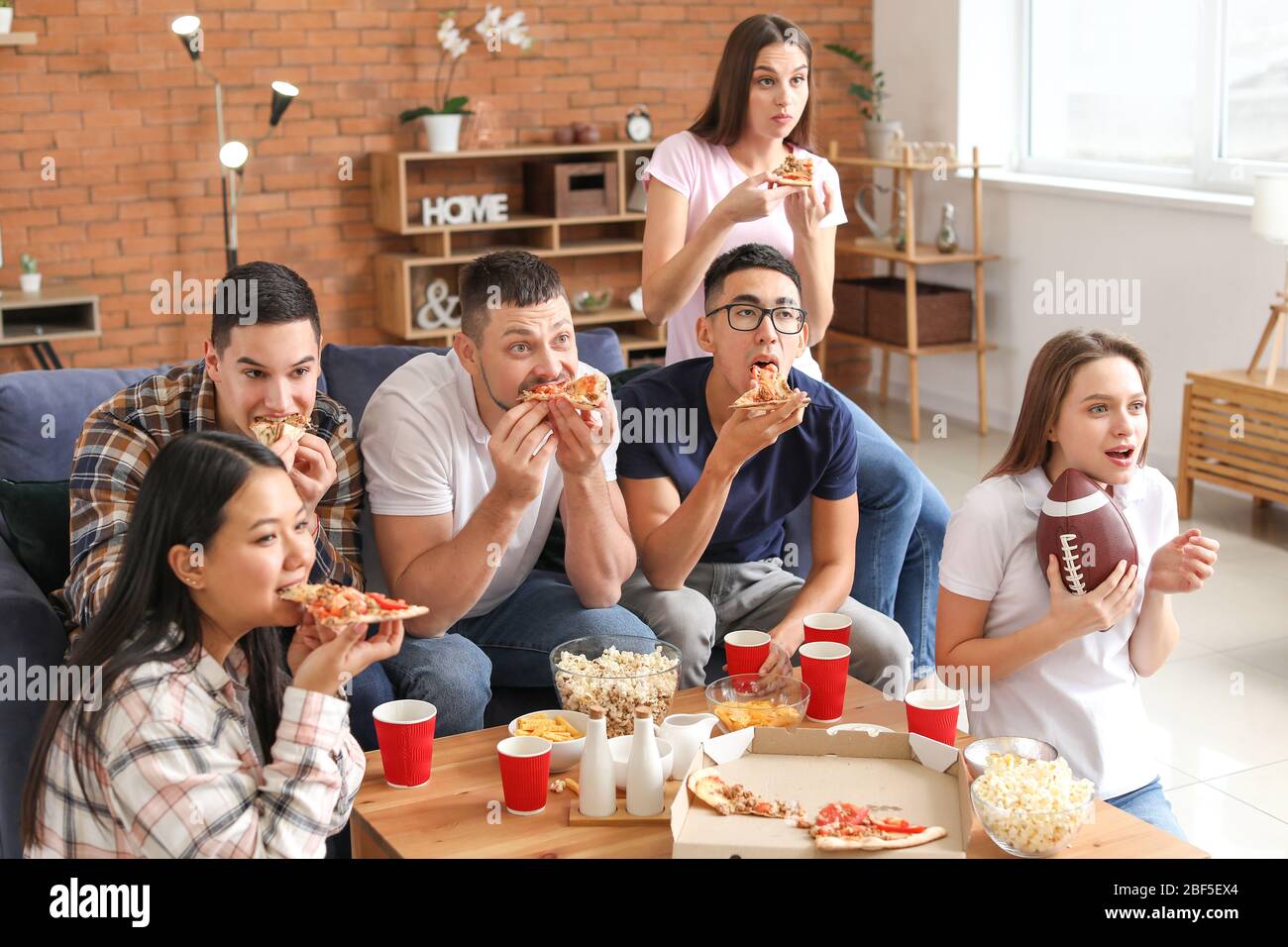 Group of fans watching rugby on TV Stock Photo - Alamy
