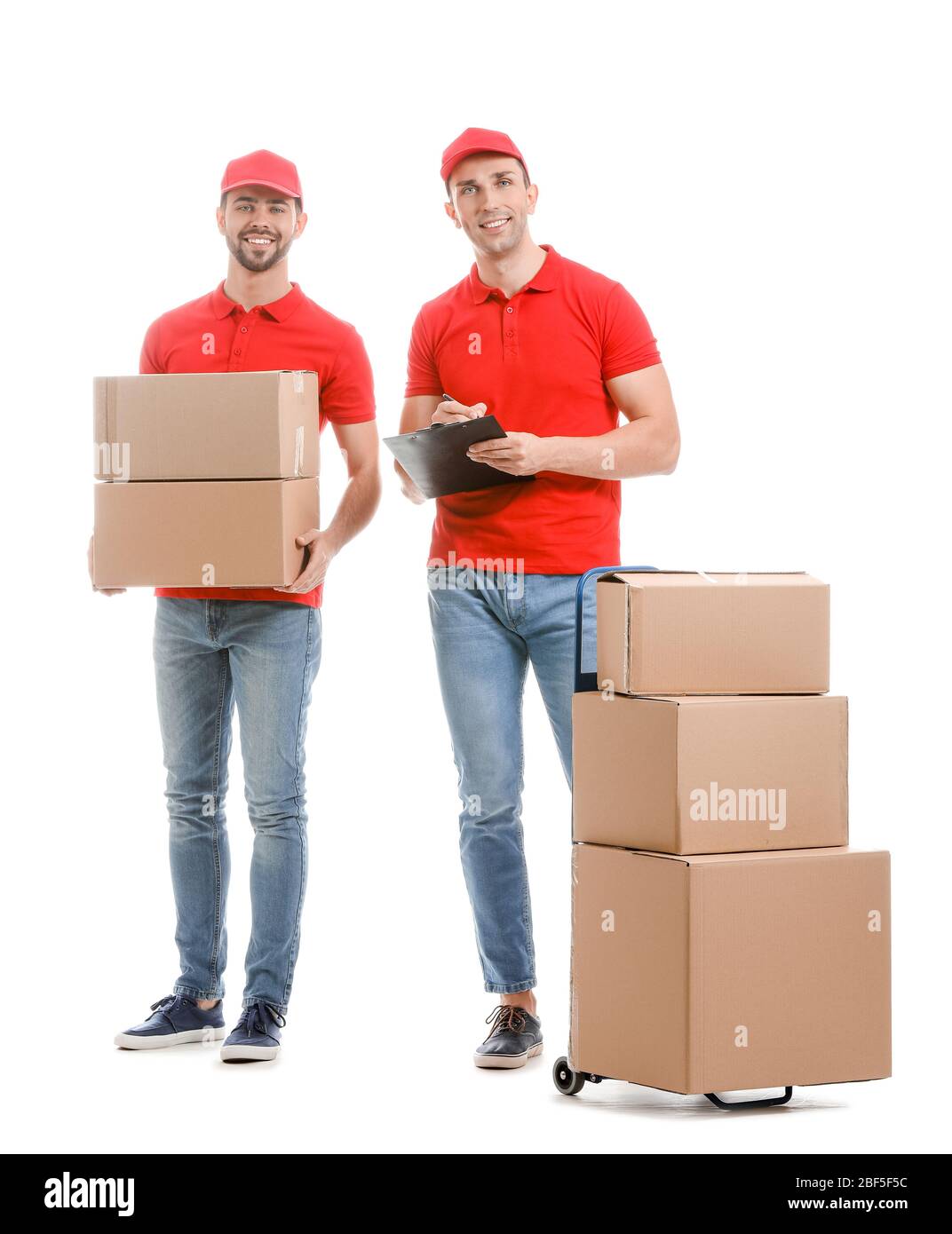 Delivery men with boxes on white background Stock Photo - Alamy