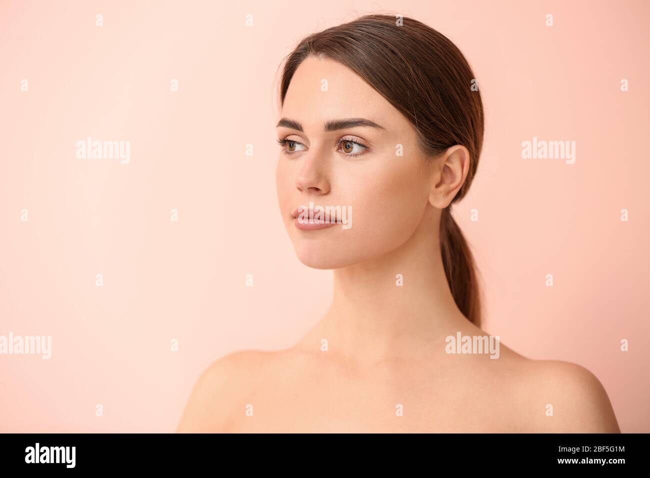 Beautiful young woman on color background. Plastic surgery concept ...