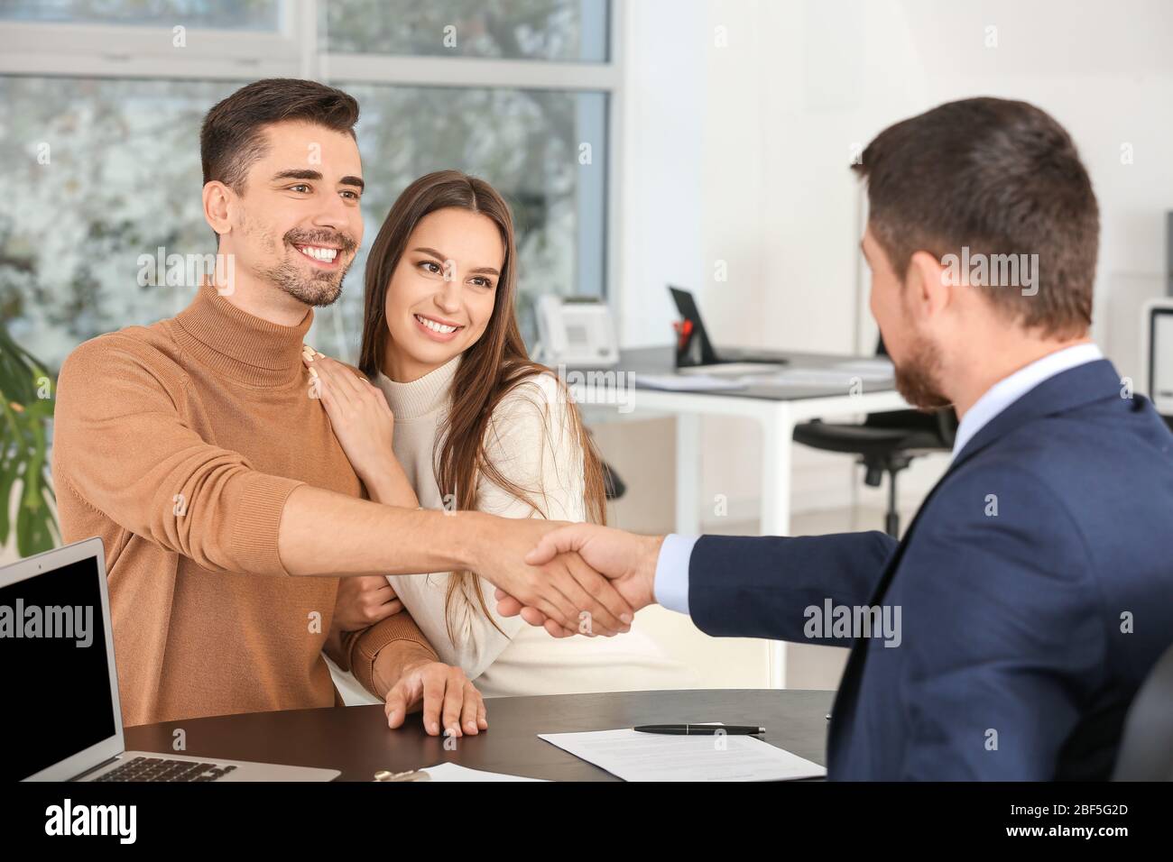 Bank manager and shaking hands hi-res stock photography and images - Alamy