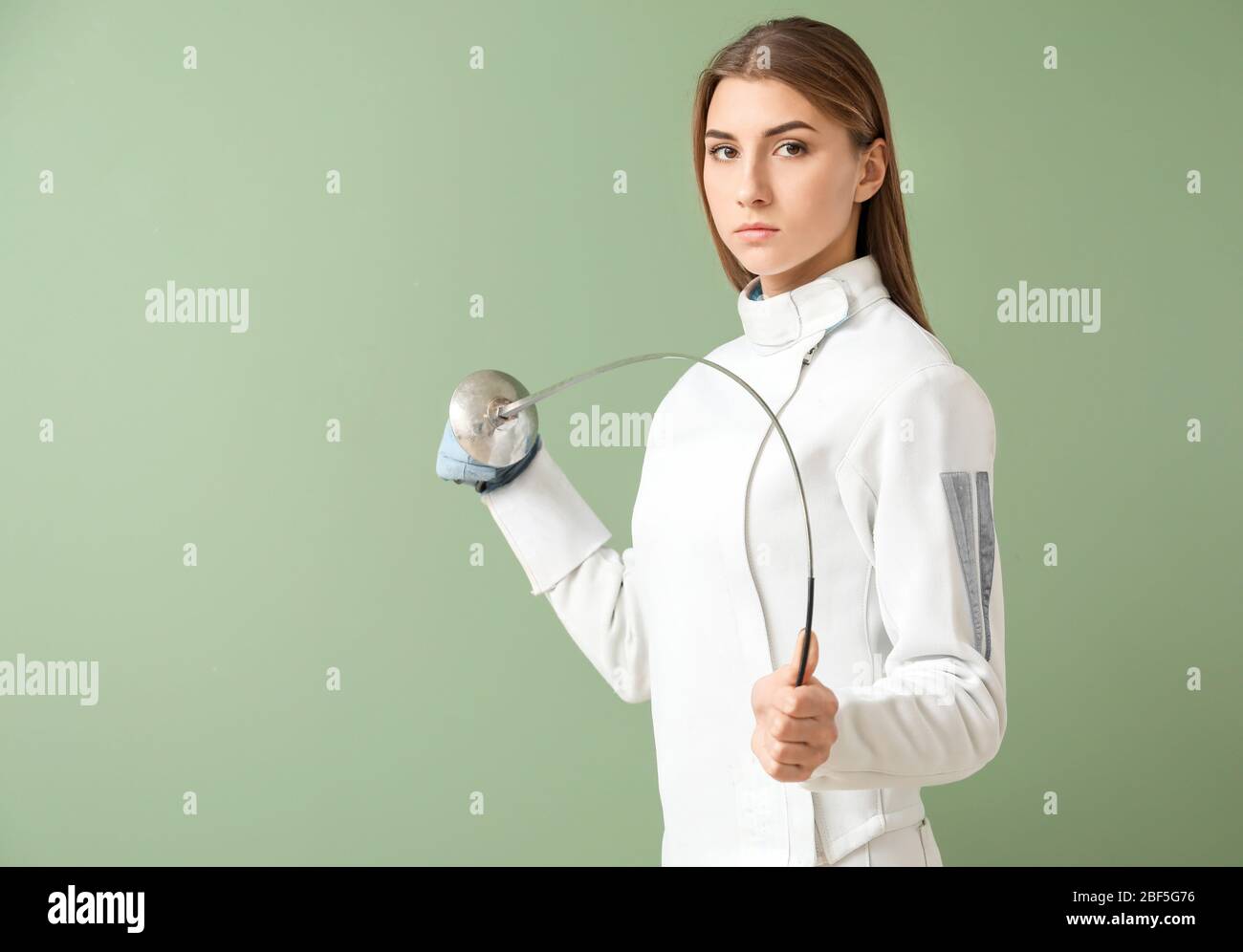 Young female fencer on color background Stock Photo - Alamy
