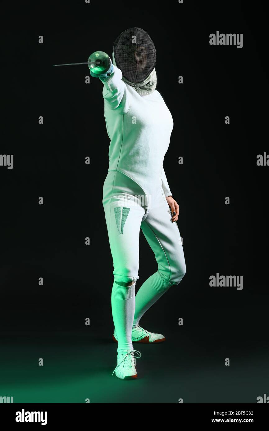 Young female fencer on dark background Stock Photo - Alamy