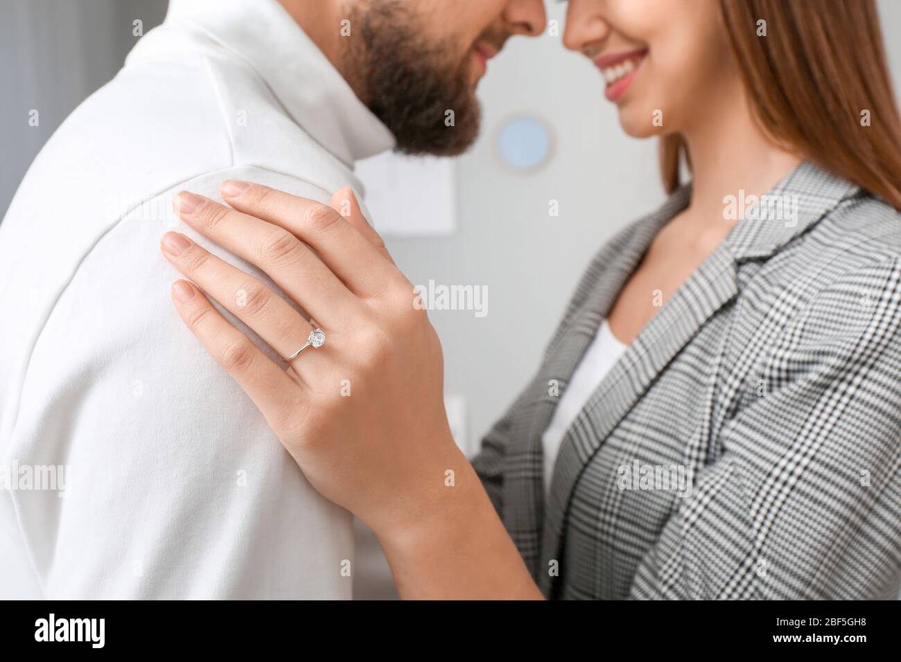 Happy engaged young couple at home Stock Photo - Alamy