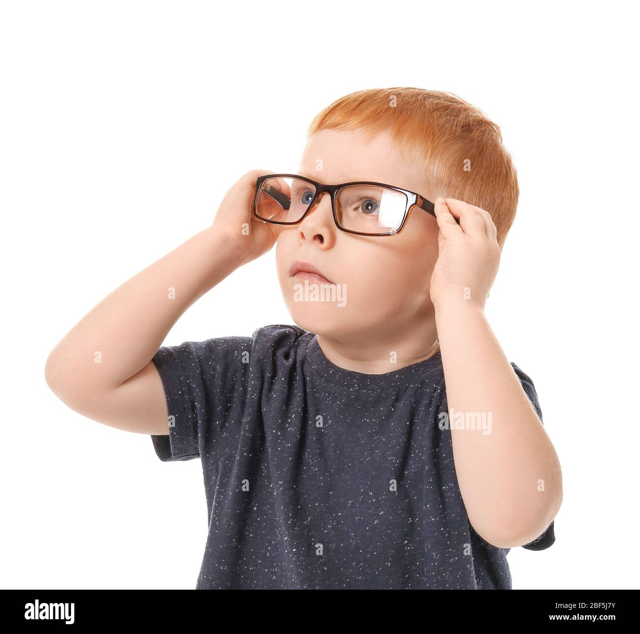 Cute little boy wearing eyeglasses on white background Stock Photo - Alamy