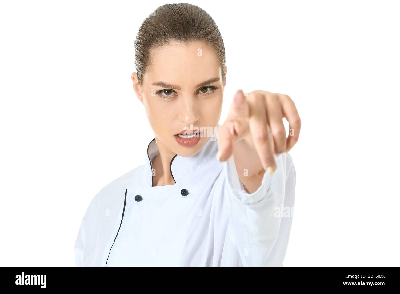 Beautiful female chef pointing at viewer against white background Stock ...