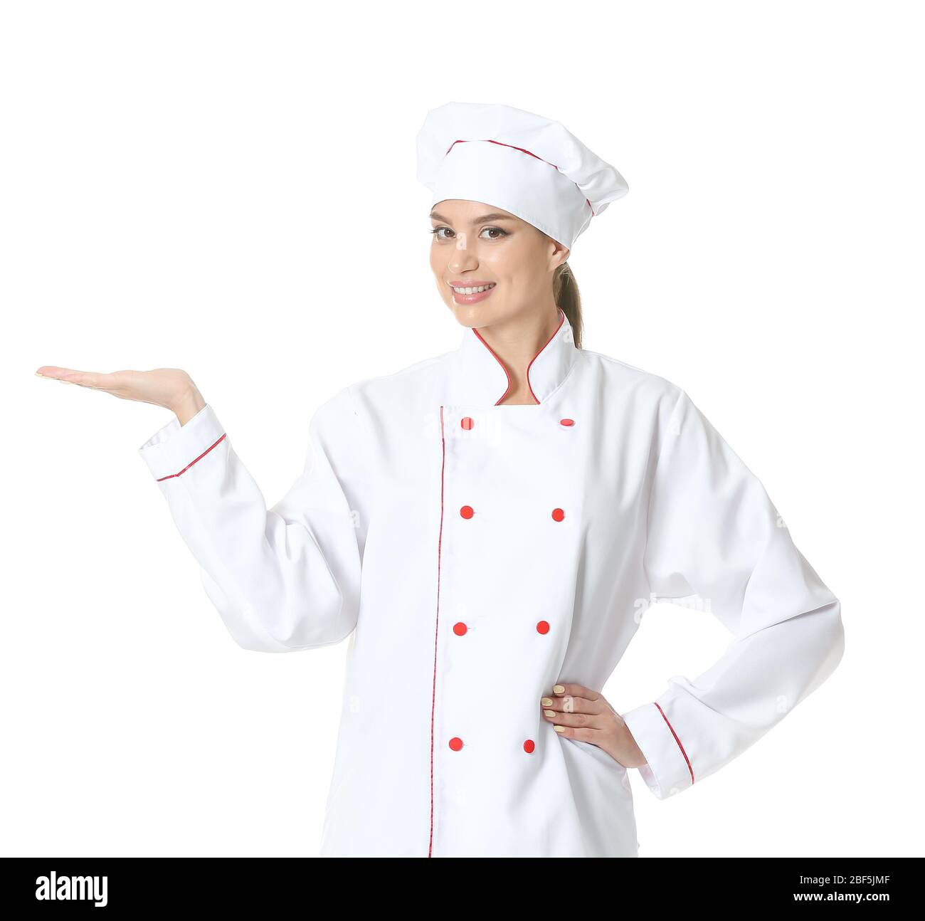 Beautiful female chef showing something on white background Stock Photo ...
