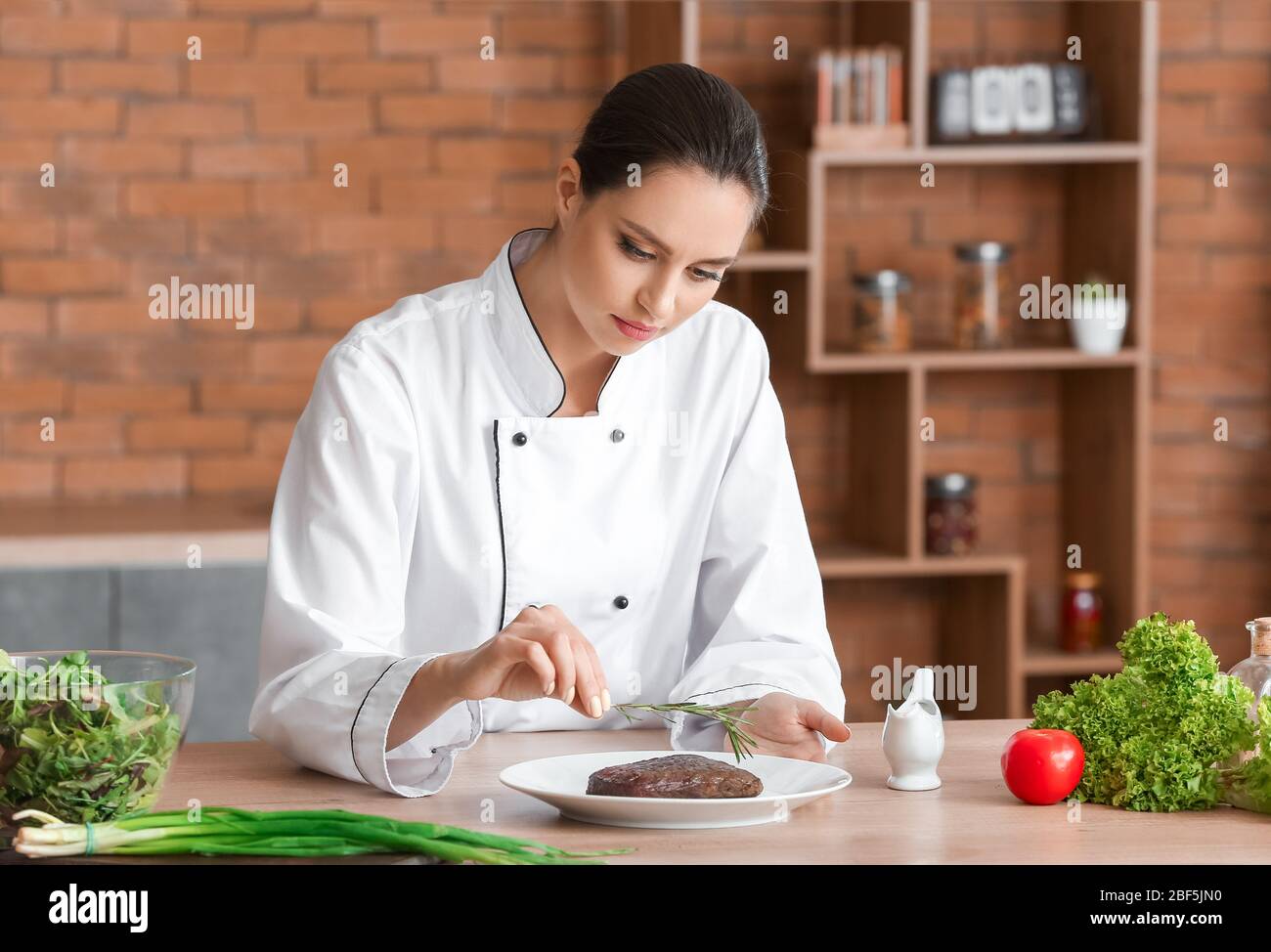Beautiful woman adding spices hi-res stock photography and images - Alamy