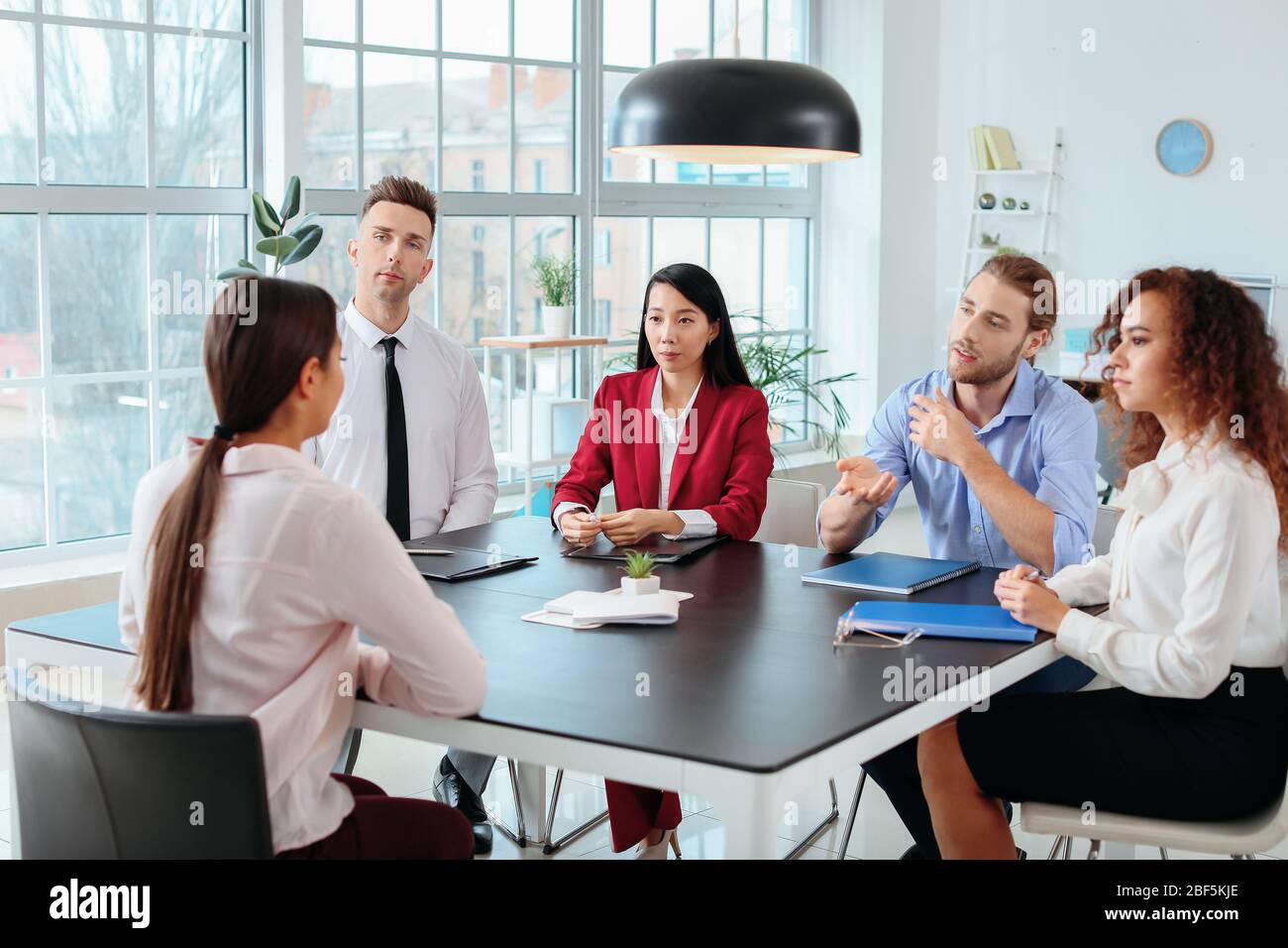 Human resources commission interviewing woman in office Stock Photo - Alamy