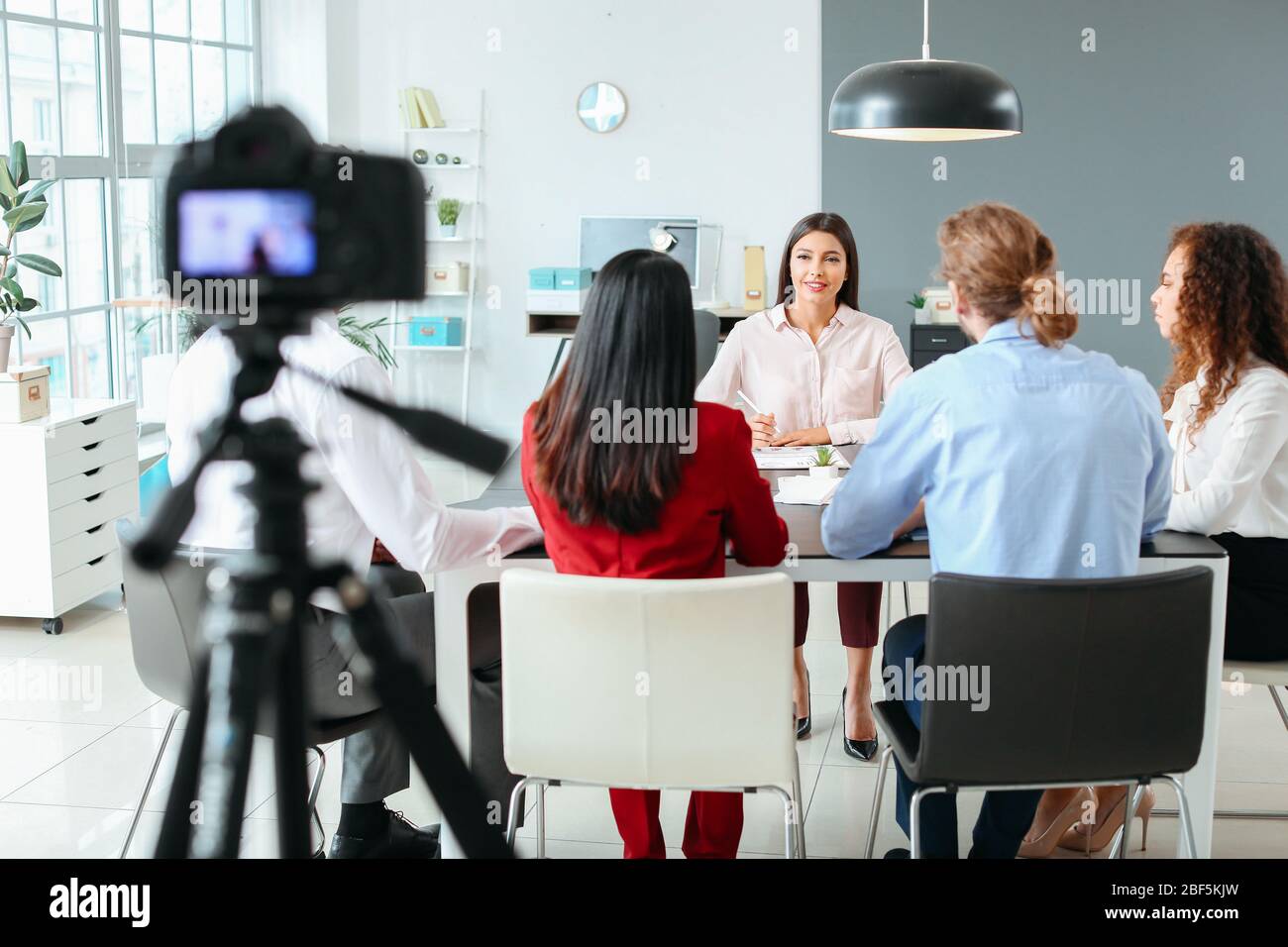Filming of job interview with applicant in office Stock Photo - Alamy