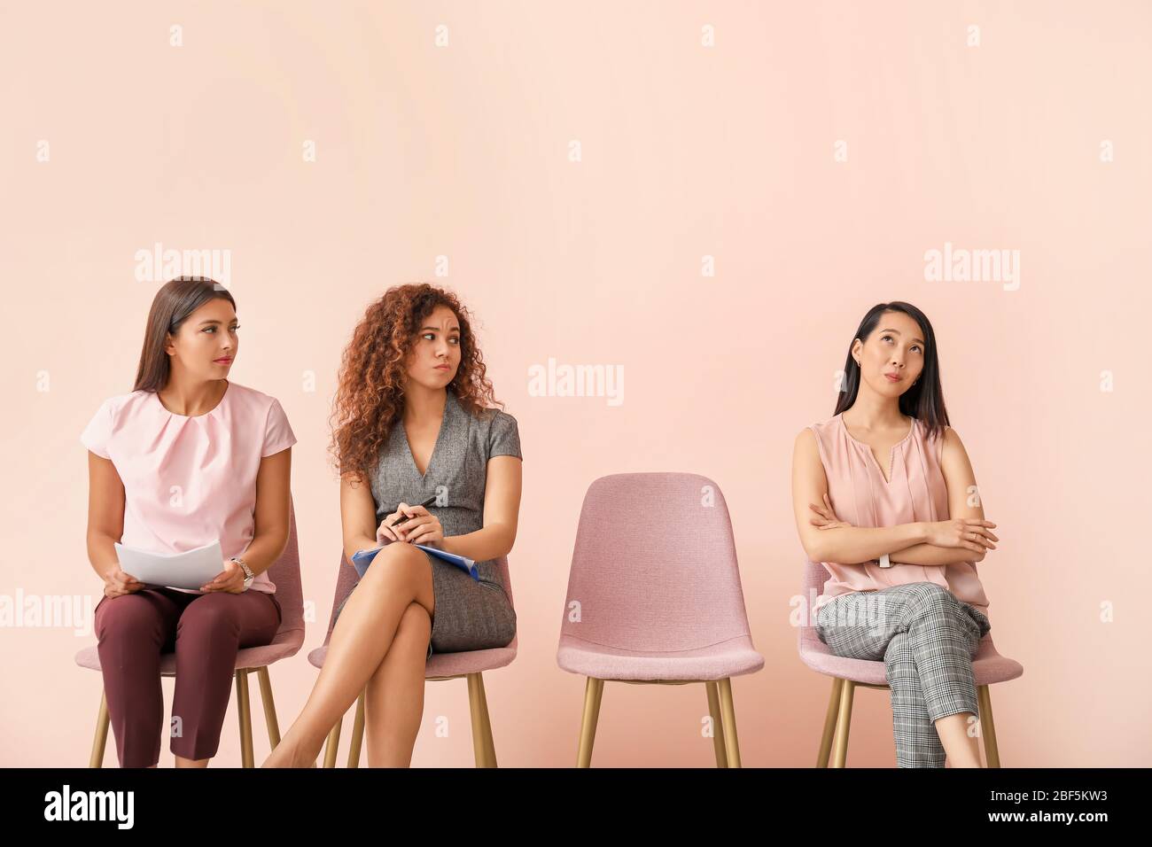 Young women waiting for job interview indoors Stock Photo - Alamy