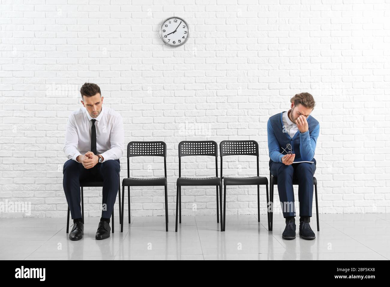 Young men waiting for job interview indoors Stock Photo - Alamy