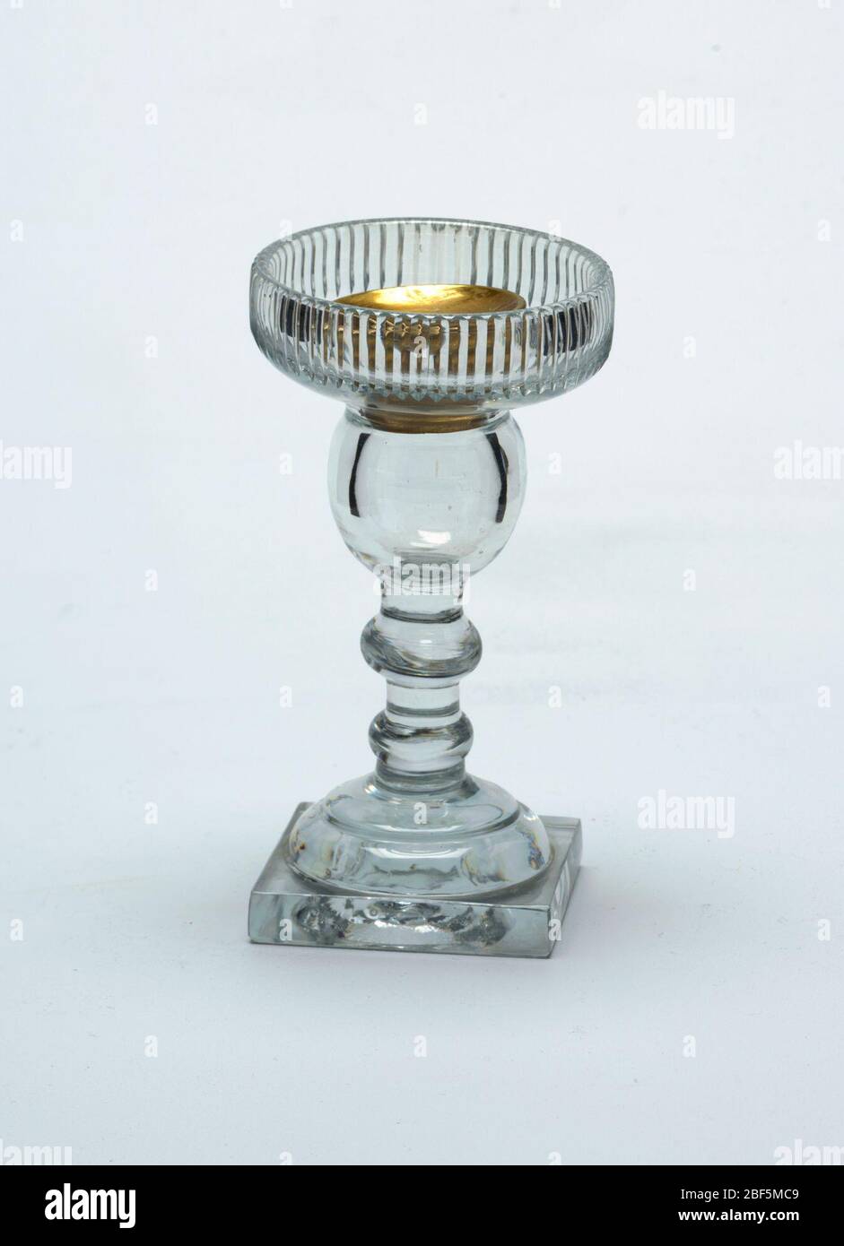 Candlestick. Tall double-knopped shaft on domed, stepped base with ...