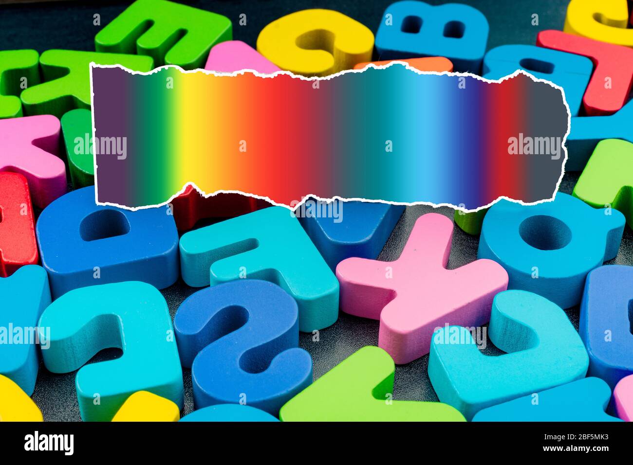 Torn paper placed on Colorful Letters of Alphabet Stock Photo - Alamy