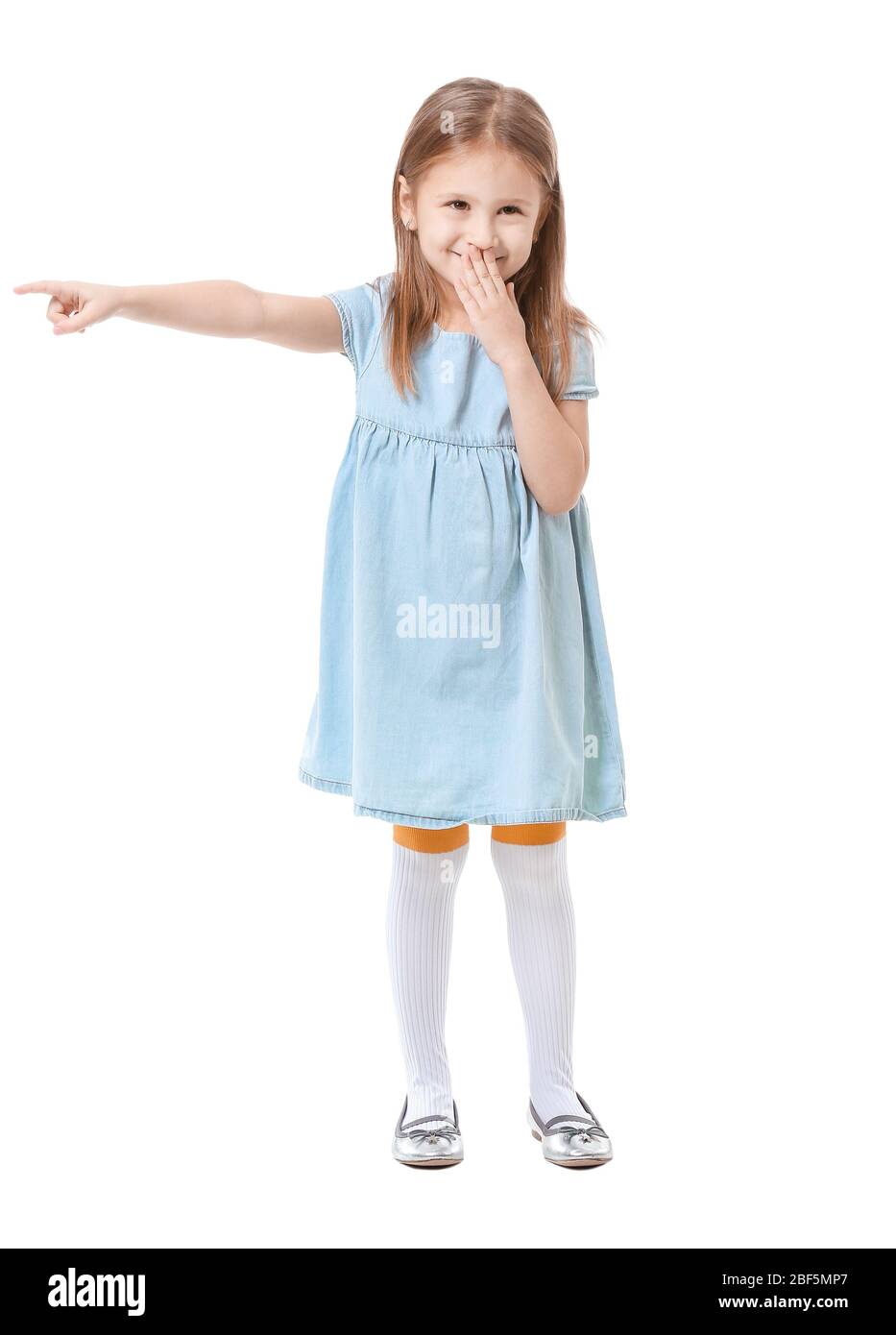 Cute little girl showing something on white background Stock Photo - Alamy