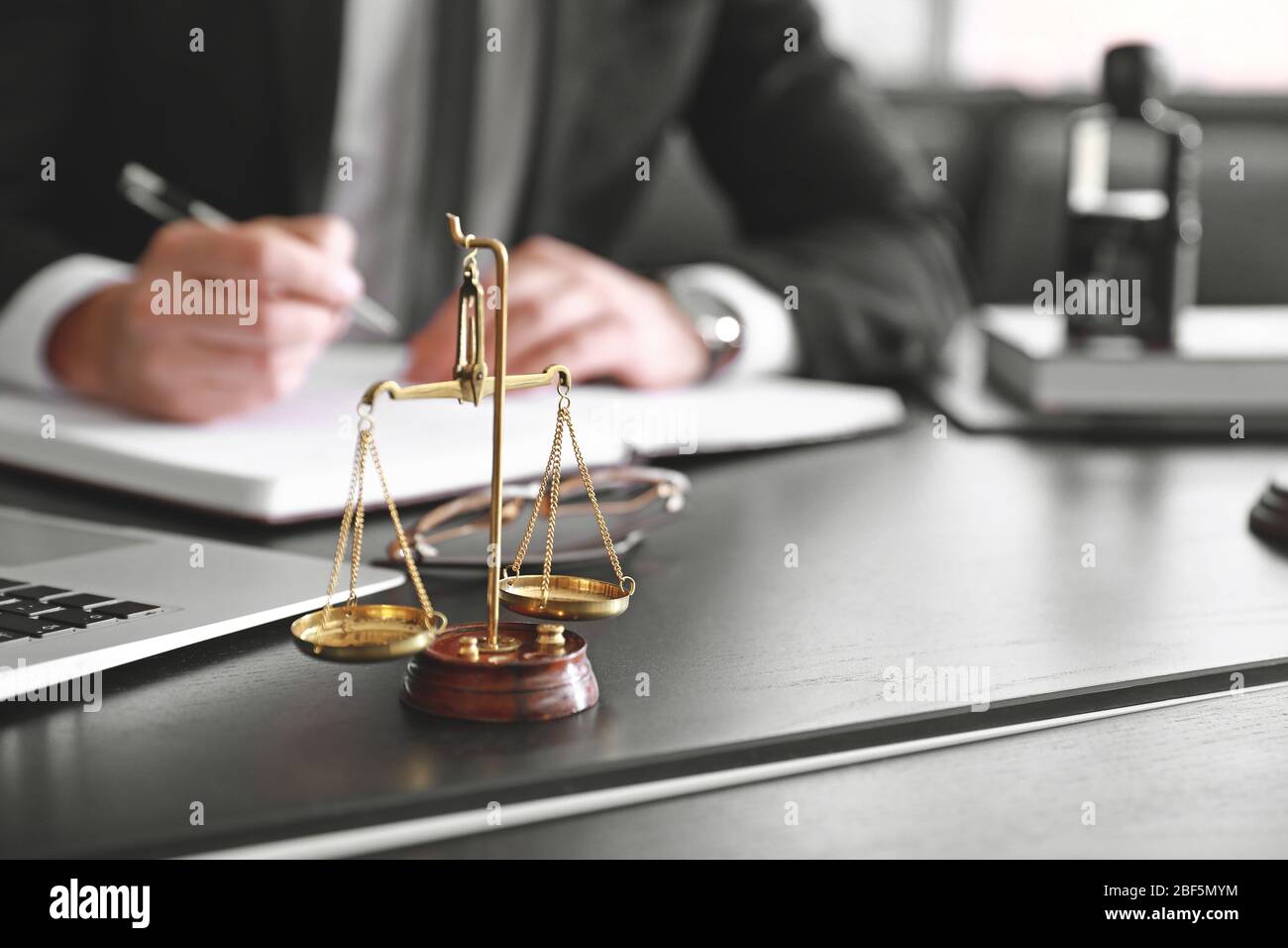 Scales of justice on table of notary public in office Stock Photo - Alamy