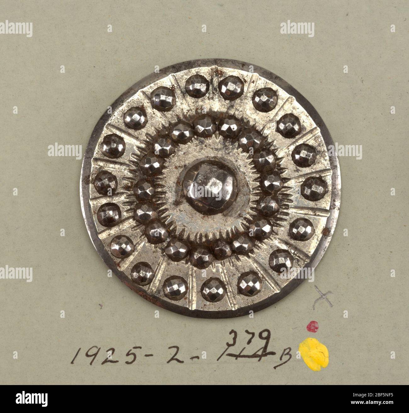 Buttons. Two flat buttons with shanks; b/: circular, plain edge with ...