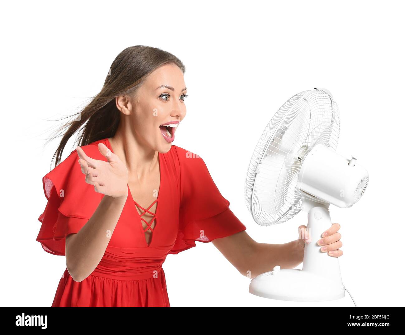 Happy woman with electric fan on white background Stock Photo - Alamy